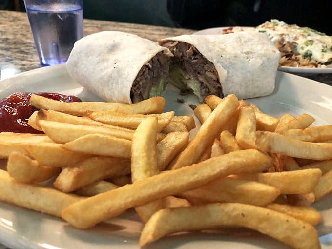 This wrap isn't just lunch—it's a hand-held vacation with fries that have achieved the golden crispness we all aspire to in life.