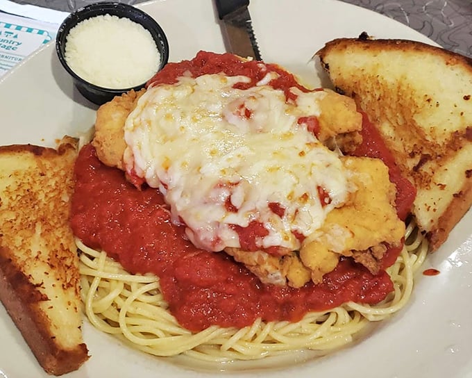 Chicken Parmesan that doesn't mess around—a mountain of melted cheese, marinara, and pasta that requires both commitment and stretchy pants.