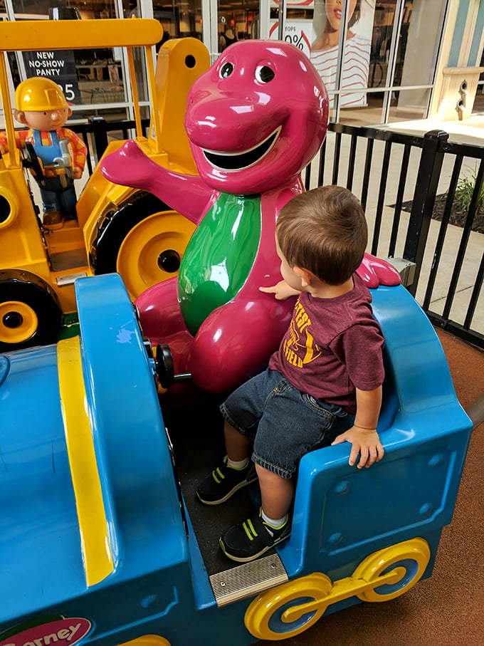 The kiddie ride zone—where loose change transforms into three minutes of childhood bliss and a brief respite for parents' aching feet.