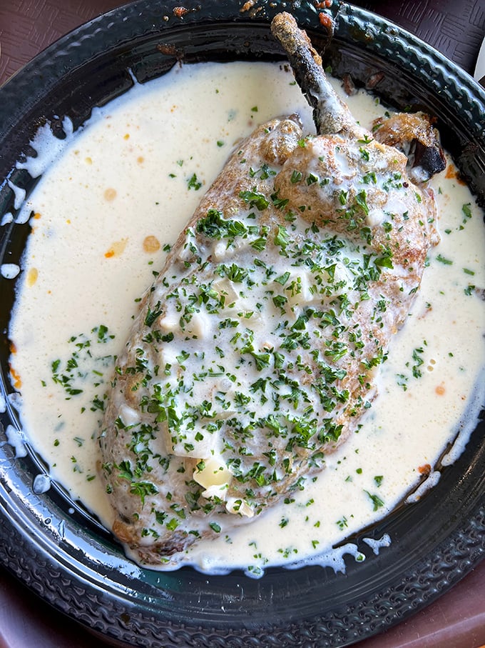This chile relleno swimming in creamy sauce isn't just food—it's edible poetry with a kick that whispers "worth every calorie."