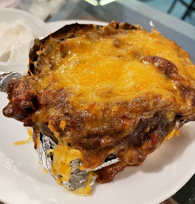 This loaded baked potato isn't just comfort food—it's a warm hug after a long day of swimming, complete with a cheesy blanket.