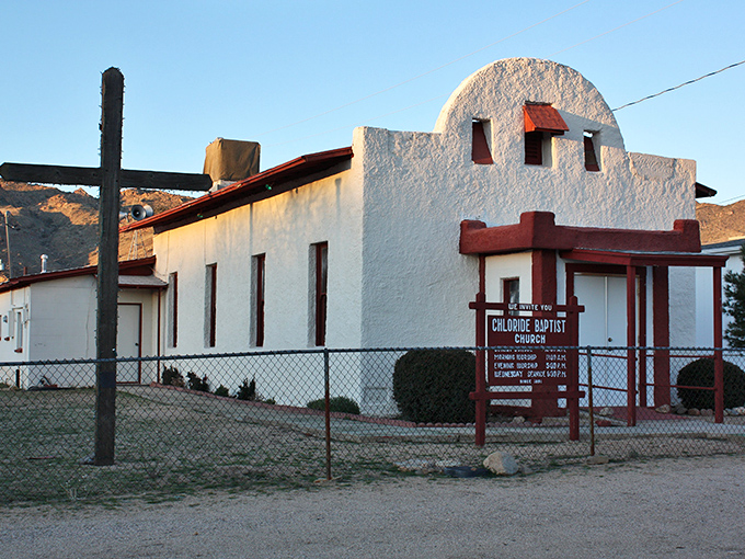 The whitewashed Chloride Baptist Church stands in stark contrast to the rugged mountains behind it – a spiritual anchor in this desert mining community.