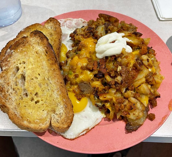 Chorizo hash topped with melted cheese and sour cream—proof that breakfast potatoes can be the main event, not just a supporting player.