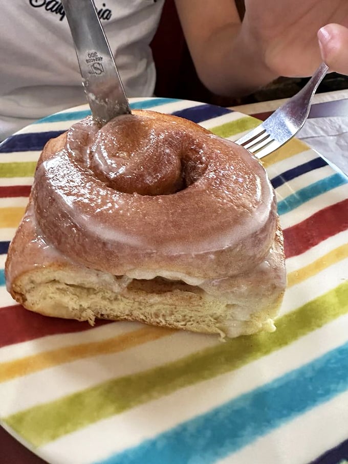 This cinnamon roll isn't just glazed, it's living its best life – soft, spiraled perfection that's worth every sticky finger that follows.