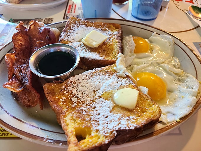 French toast dusted with powdered sugar, bacon crisped to perfection, and sunny-side-up eggs—breakfast doesn't get more textbook perfect than this.