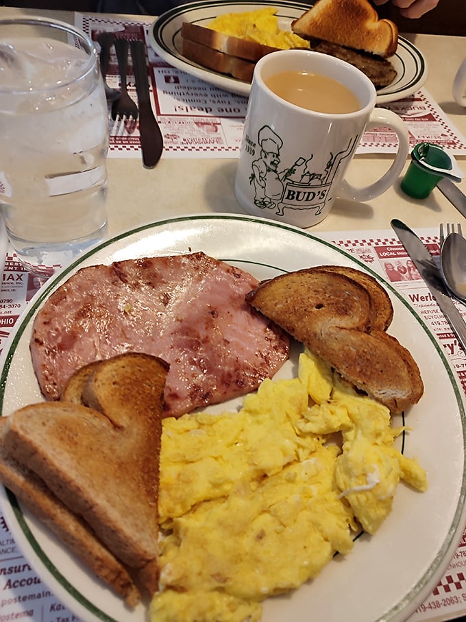 The breakfast trinity—perfectly scrambled eggs, toast with just the right amount of butter, and ham that reminds you why breakfast is worth waking up for.