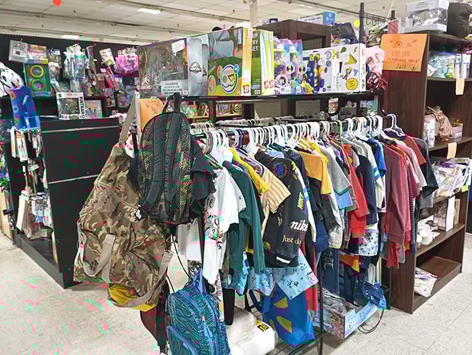 The clothing racks—where vintage tees and yesterday's fashion finds become tomorrow's retro statement pieces. That camo backpack has seen some adventures.