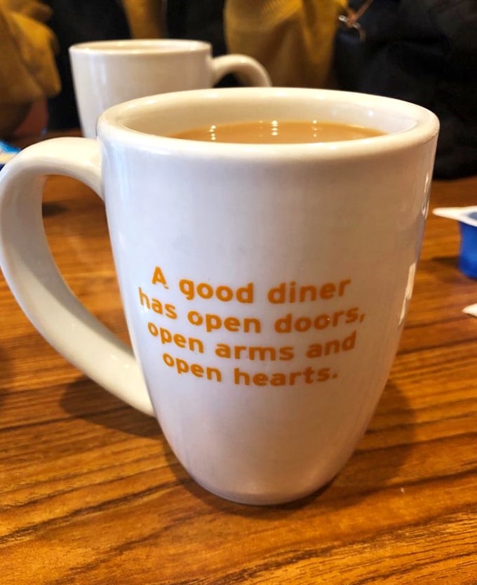 A coffee mug that speaks the truth—diners aren't just about food, they're community centers with better coffee and no membership fees.