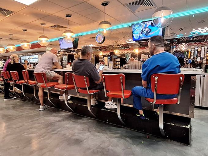 Step right up! These classic red diner stools practically whisper, “Sit down, friend—stories and coffee await.