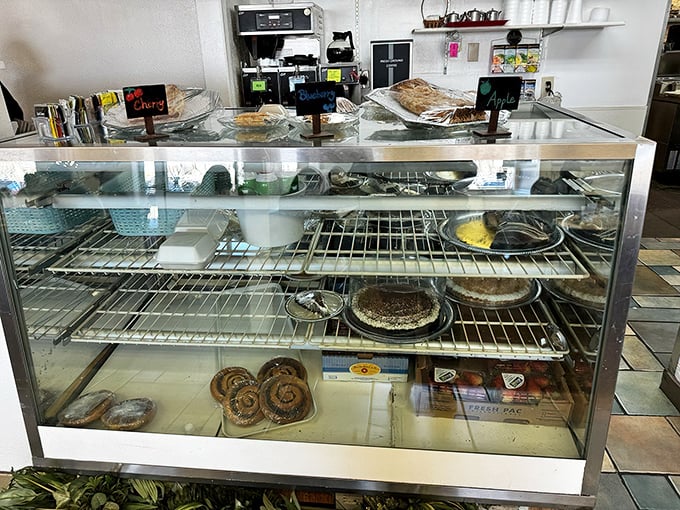 The dessert case – where willpower goes to surrender. Those cinnamon rolls are worth every extra minute on the treadmill.