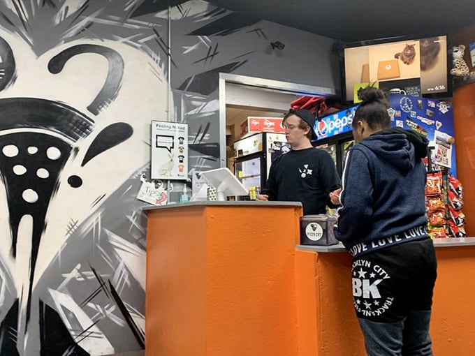 The ordering counter—where pizza dreams come true and diet plans go to die. Worth every delicious calorie that follows.