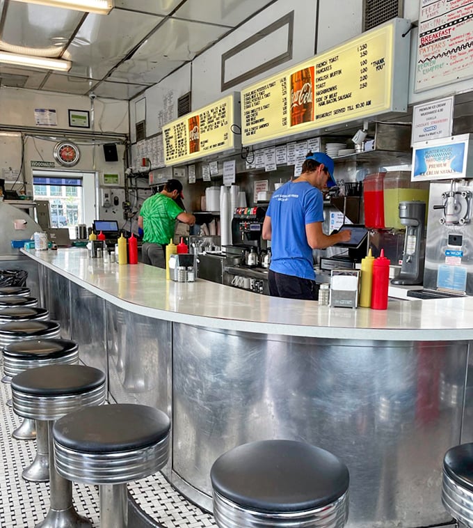 The stainless steel counter and classic stools create the perfect stage for burger enjoyment—where every seat feels like the best in the house.