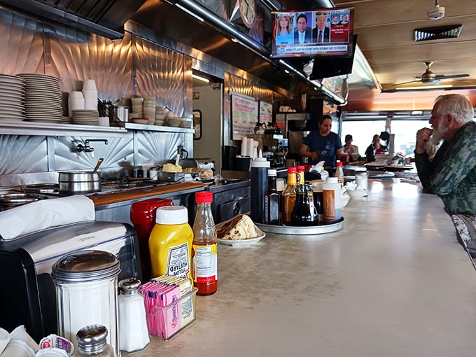 The counter—where solo diners never feel alone, newspapers get properly read, and the waitstaff performs the ballet of plates and conversation.