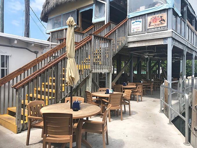 Waterfront deck seating where gentle breezes and boat watching enhance every bite of fresh seafood perfection.