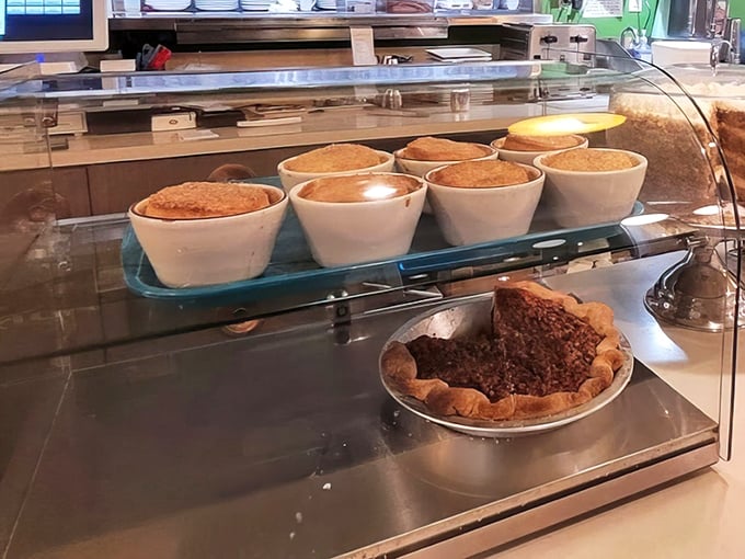 The dessert case—temple of temptation where willpower goes to die. Those pies aren't just desserts; they're reasons to save room.
