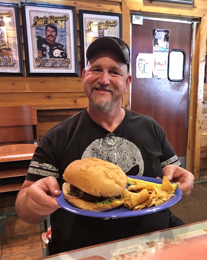 The face of a man who's about to embark on a delicious journey. That burger isn't just a meal—it's a memory in the making.