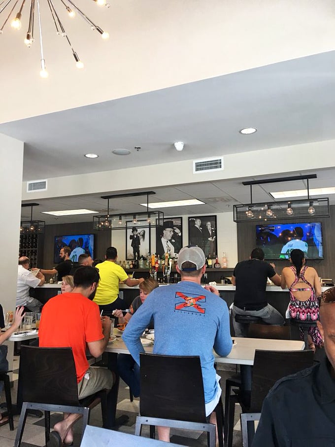 Where deli dreams come true—patrons enjoying the fruits of Top Hat's labor while sports play silently in the background. The perfect Florida afternoon.