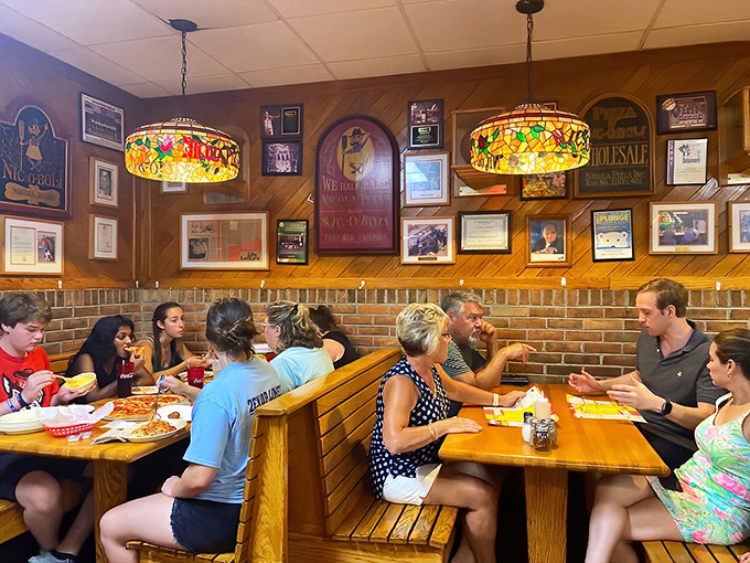 Happiness is a table full of people sharing pizza – these folks clearly understand life's simple pleasures.