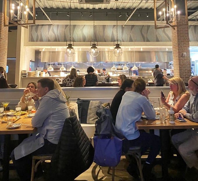 The open kitchen design isn't just for show – it's dinner and a performance where every plate is the star.