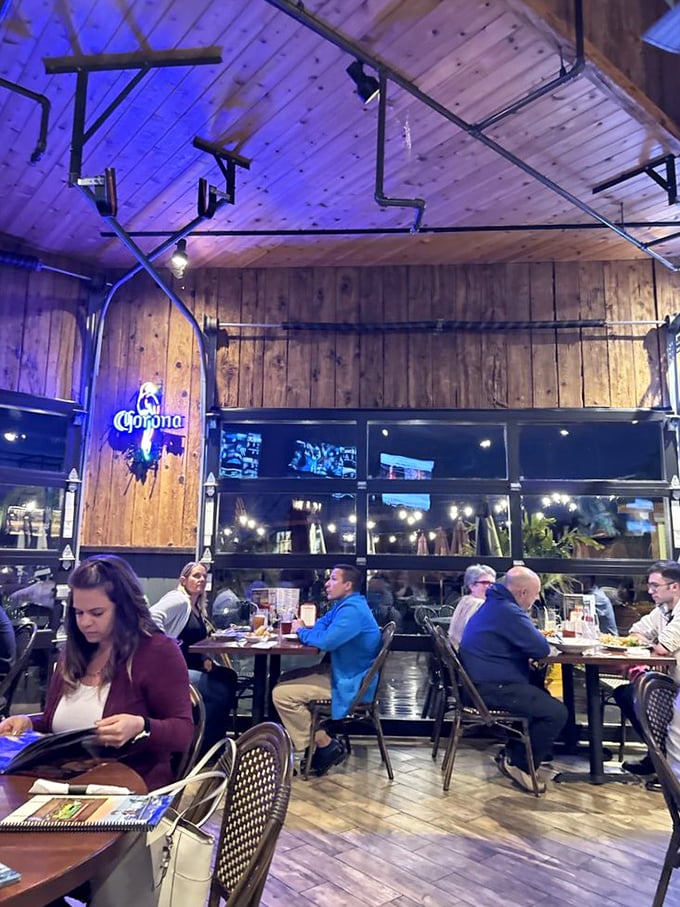 Evening dining under wooden beams and blue light—where conversations flow as smoothly as the drinks.