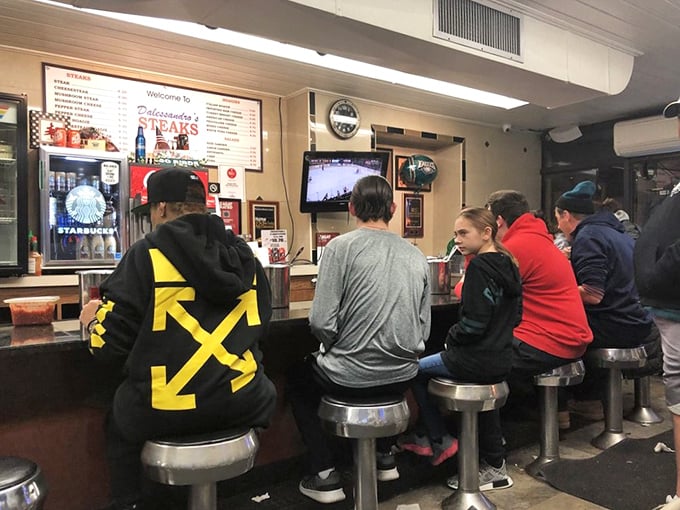 The lunch counter fills with devoted fans. In Philadelphia, cheesesteak appreciation transcends all social boundaries.