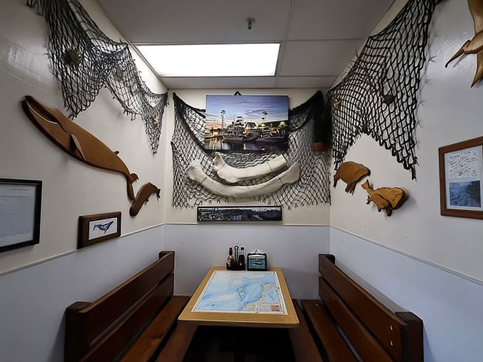 This cozy nook with fishing nets and wooden fish sculptures feels like dining inside a ship captain's personal quarters—minus the seasickness.