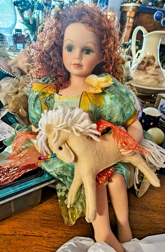 Porcelain perfection meets childhood nostalgia in this red-haired doll, complete with felt unicorn companion—someone's cherished memory.