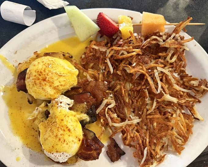 Eggs Benedict swimming in creamy hollandaise—a breakfast classic executed with the reverence it deserves.