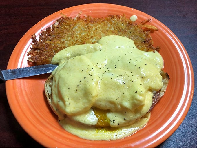 Eggs Benedict with hollandaise that cascades like a yellow waterfall over English muffins – morning decadence defined.