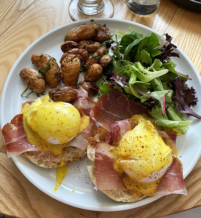 These eggs Benedict have dressed for the occasion, draped in prosciutto with a supporting cast of crispy potatoes and fresh greens.