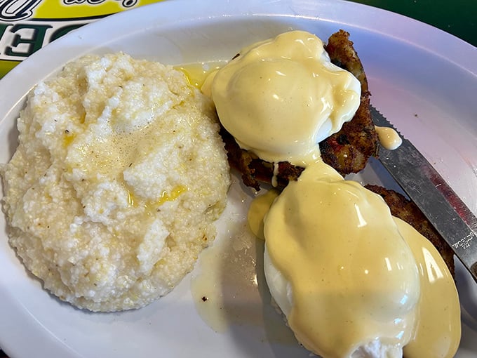 Eggs Benedict that doesn't need a fancy brunch setting to shine—just perfectly poached eggs, creamy hollandaise, and buttery grits.
