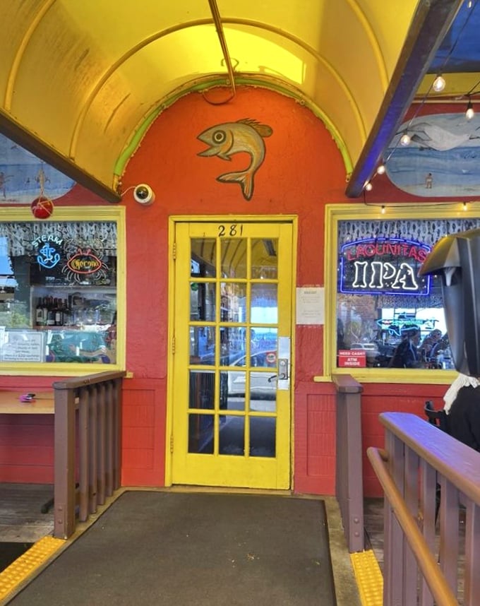 The yellow door framed by red walls and neon beer signs—a portal to seafood nirvana. Like following the yellow brick road, but it leads to fish instead of wizards.