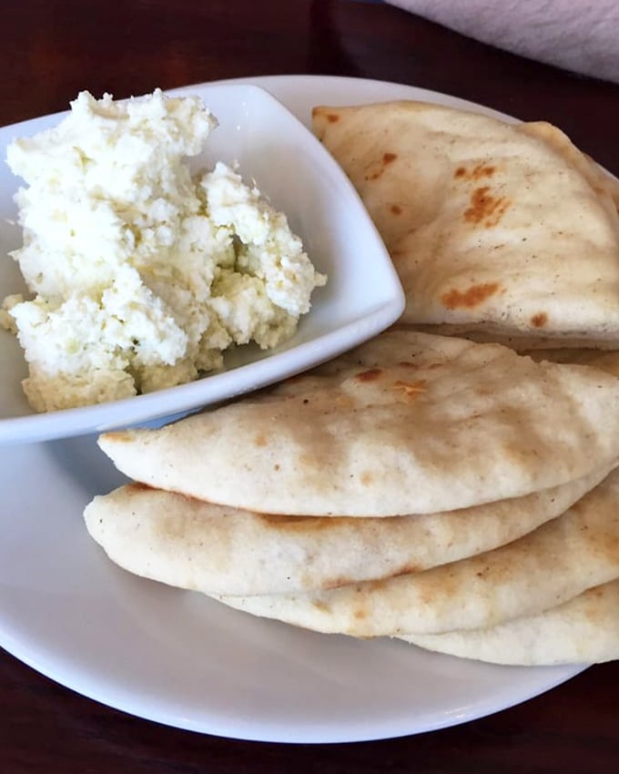 Pillowy pita triangles surrounding a cloud of feta spread—a simple starter that's caused more than one dinner guest to forget about the main course.