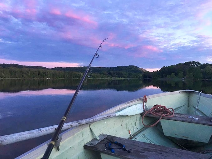 Dawn fishing from a weathered boat—Michigan's version of meditation. That pink-purple sky is nature showing off its Photoshop skills without using Photoshop.
