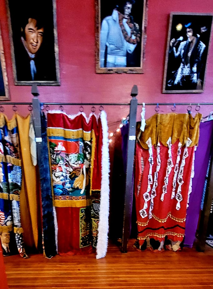 The King watches from above as bold curtains turn these fitting rooms into a stage of their own—equal parts vintage flair and Vegas spectacle.