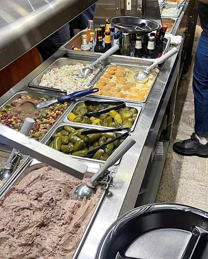 The sides station—where coleslaw, beans, and pickles patiently wait to complement your meat marathon with tangy, crunchy relief.