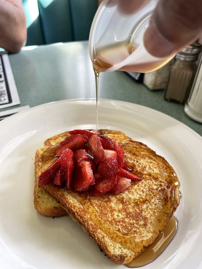French toast that's living its best life with fresh strawberries and maple syrup. Breakfast or dessert? The line blurs deliciously and nobody's complaining.