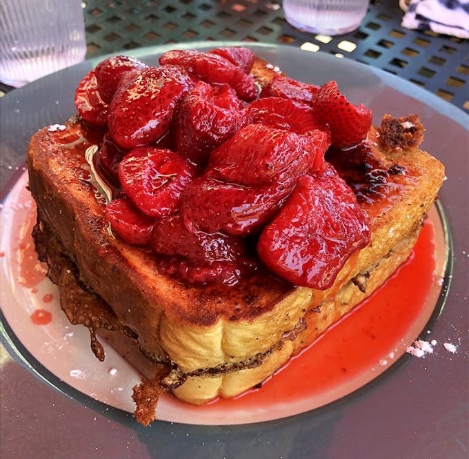 French toast that makes you question why anyone would eat regular toast ever again. Those strawberries aren't garnish – they're the crown jewels.