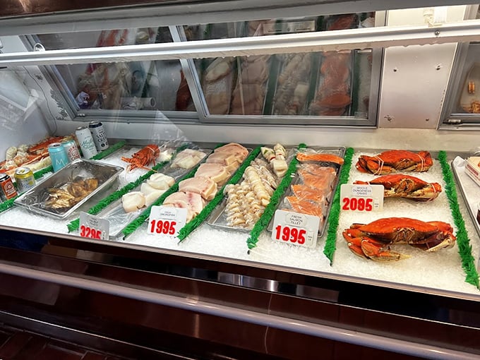 The fish market display case showcases ocean treasures on beds of ice, a reminder that at The Crab Cooker, "fresh" isn't just marketing – it's the foundation of everything they serve.