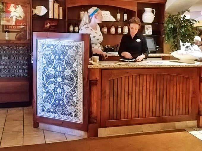 The reception desk's decorative tile work adds that touch of Mediterranean flair – first impressions matter in the restaurant world.