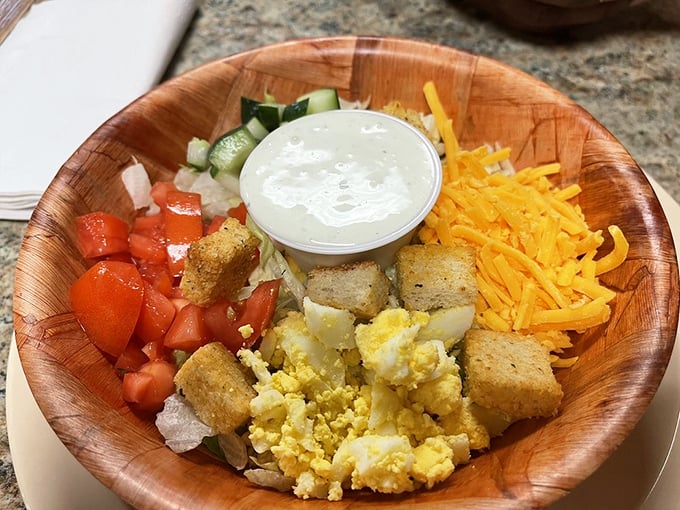A wooden bowl salad that brings garden freshness to your table. Proof that vegetables can coexist peacefully with comfort food.