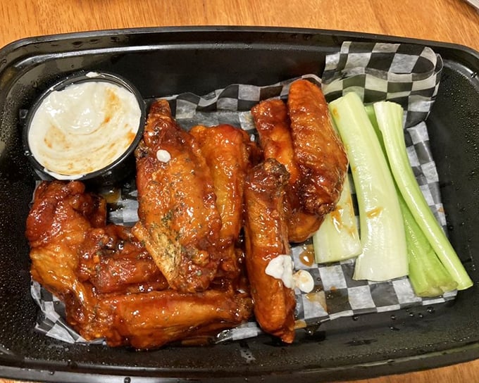 Wings that don't need a sporting event as an excuse—glazed with tangy sauce and served with the obligatory celery that nobody actually eats.