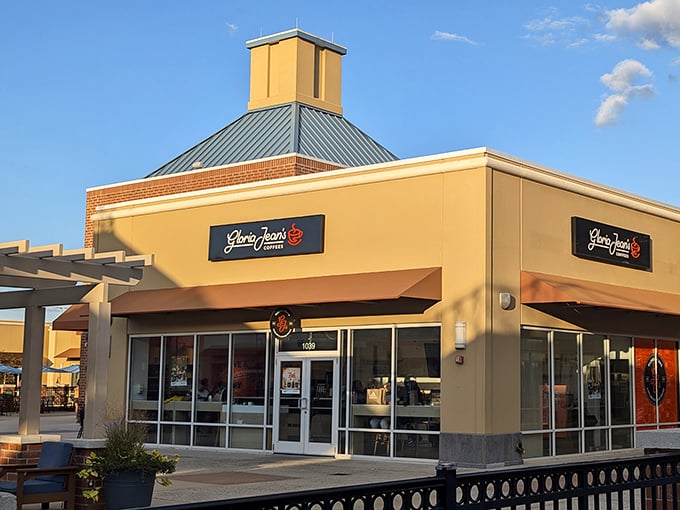 Gloria Jean's corner spot catches the golden hour light perfectly, promising caffeinated salvation to shoppers who've hit their second wind—or need to find it. 