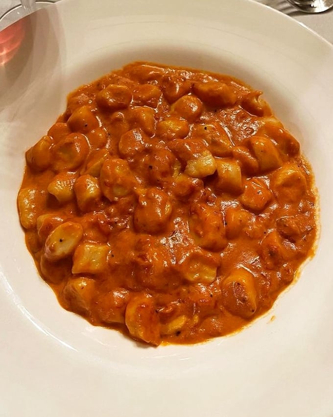Gnocchi that's having a pool party in vodka sauce—each little potato dumpling doing the backstroke through creamy, tomatoey bliss.