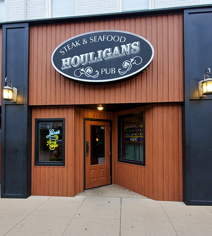 Houligans Steak & Seafood Pub wraps visitors in warm wood tones and golden light—the architectural equivalent of a hearty welcome and a firm handshake.