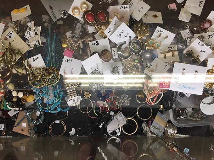 The jewelry counter requires archaeological patience—sifting through costume pieces to find that occasional genuine article hiding in plain sight.