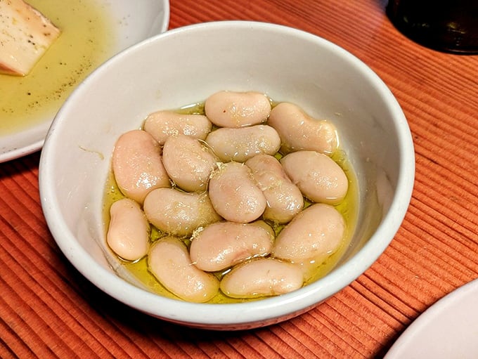Judion beans bathed in olive oil—plump, buttery legumes that could convert even the most dedicated carnivore to plant-based bliss.