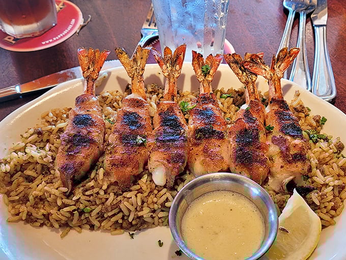 Jumbo Shrimp Brochette—bacon-wrapped treasures from the sea atop dirty rice. A dish so good it deserves its own thank-you note.
