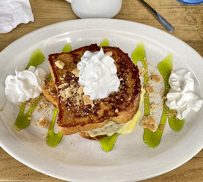 Key lime French toast that captures Florida sunshine on a plate – complete with artistic lime drizzles and whipped cream islands.