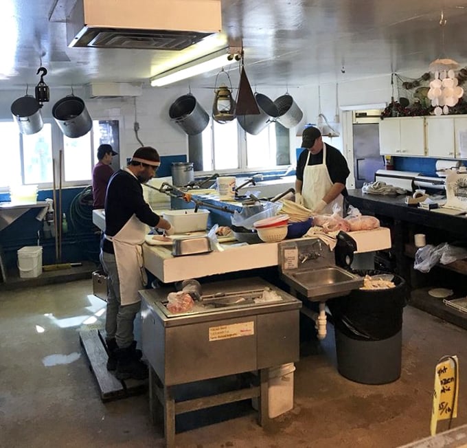 Where the magic happens. Skilled hands transform the day's catch into memorable meals with practiced efficiency in this no-frills kitchen.